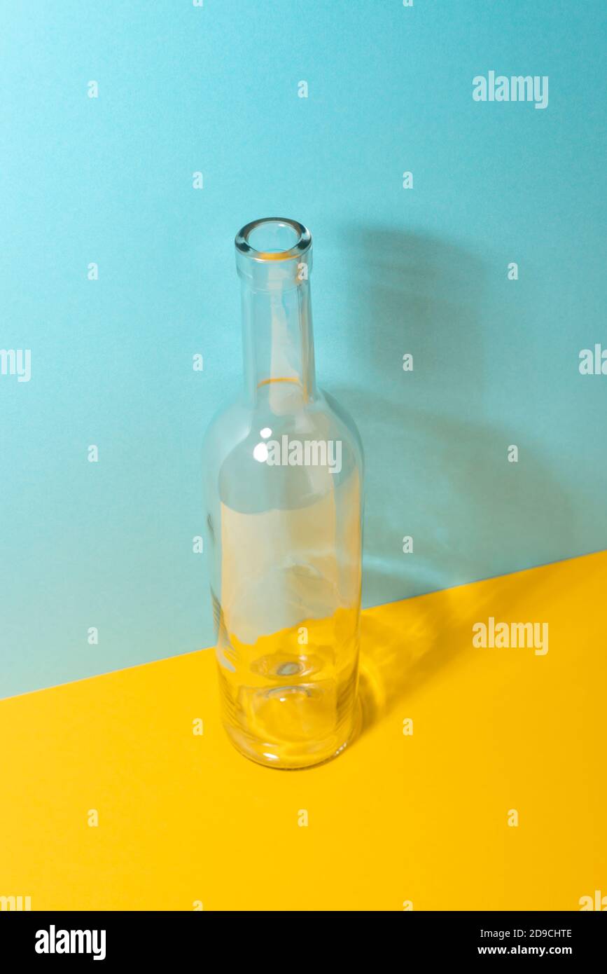 Empty transparent glass bottle on colorful background Stock Photo - Alamy