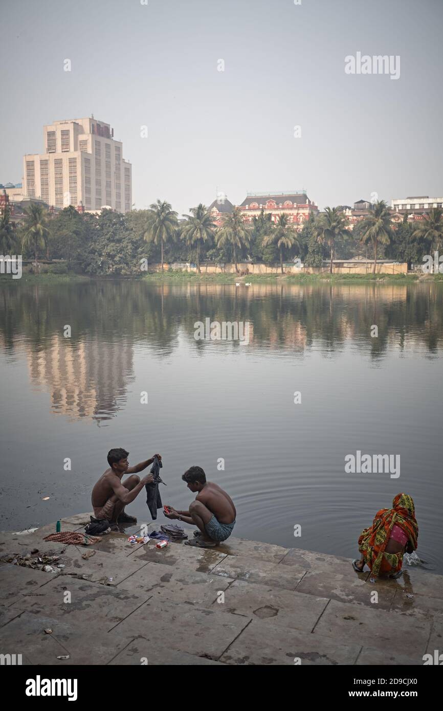 Kolkata, India, January 2008. People washing clothes in the pond of Lal ...