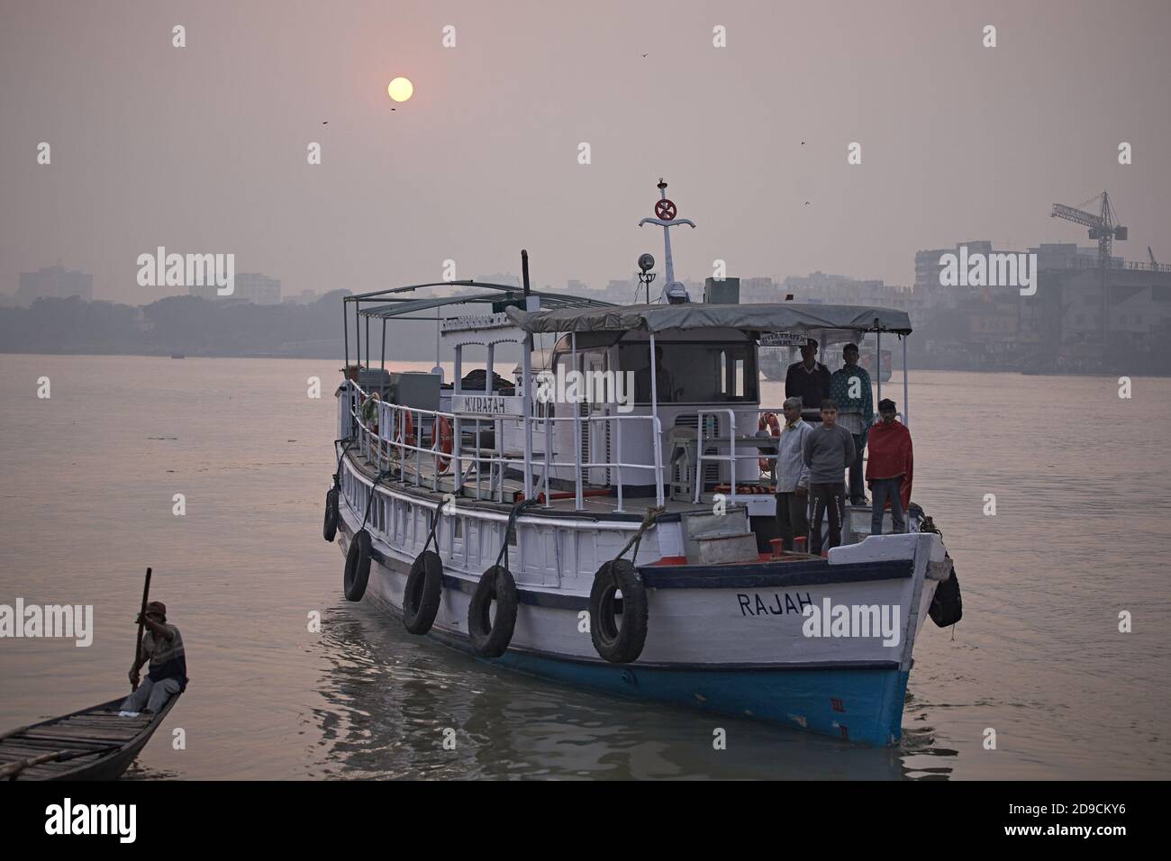 Kolkata, India, January 2008. A passenger ferry at sunset on the Ganges ...