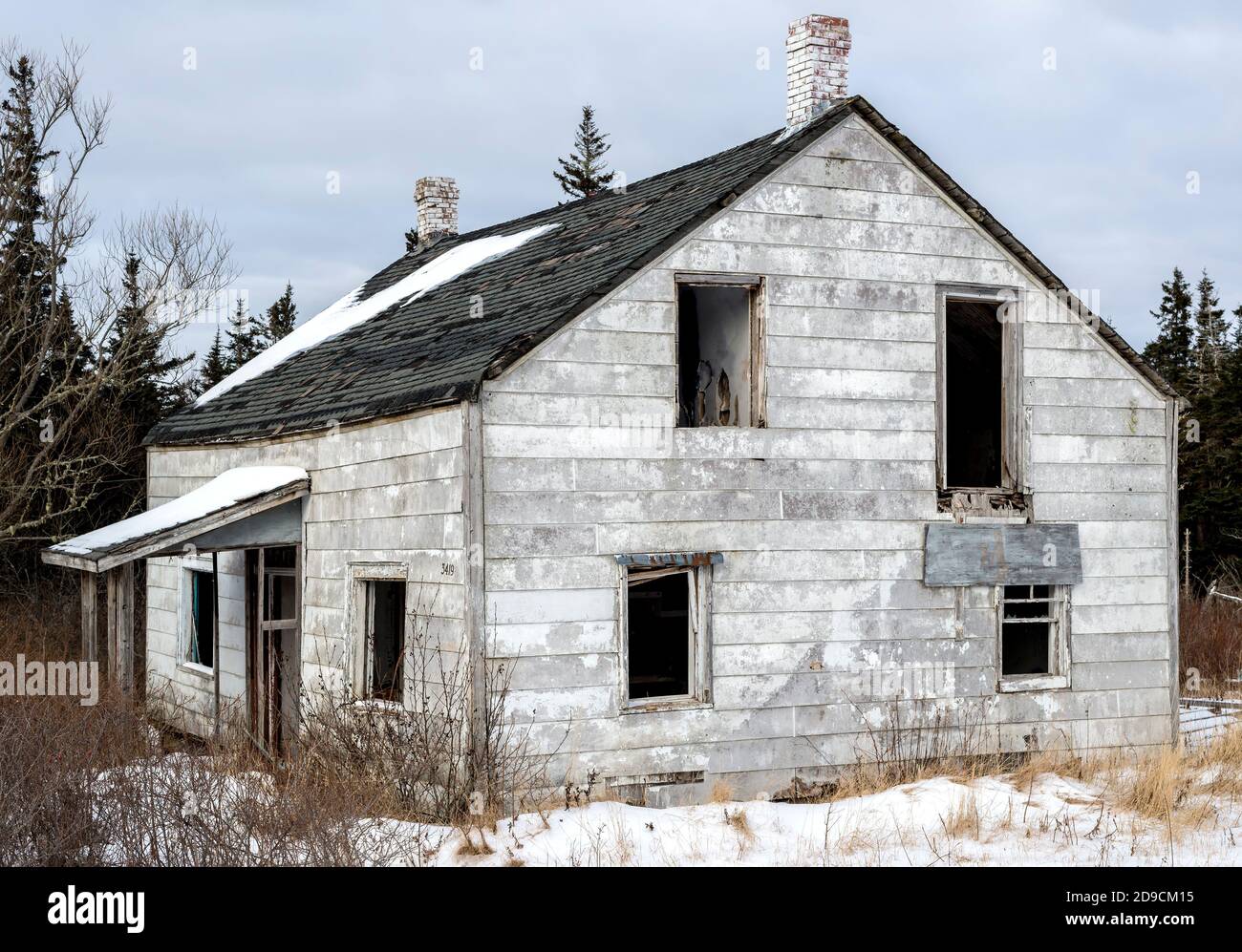 An abandoned house. Windows are missing. Roof and sides in very poor ...