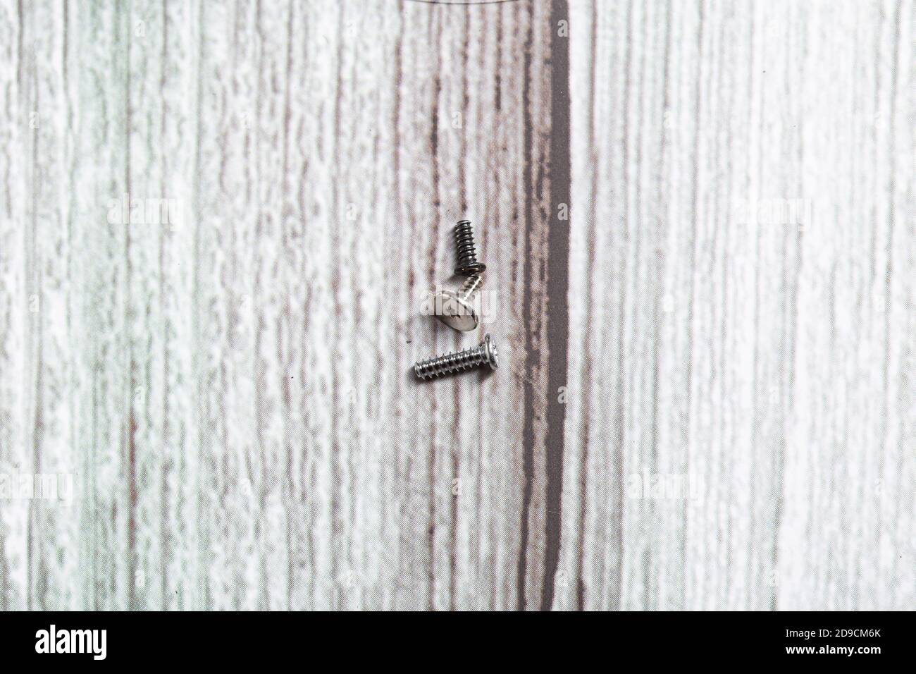 Tiny metal screws close up still Stock Photo - Alamy