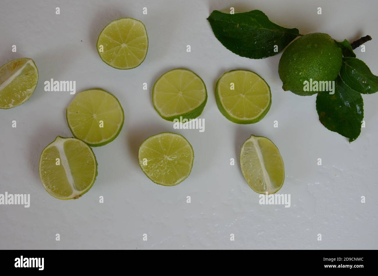 Flat lay of citrus fruits like lime and lemon with lemon tree leaves on ...
