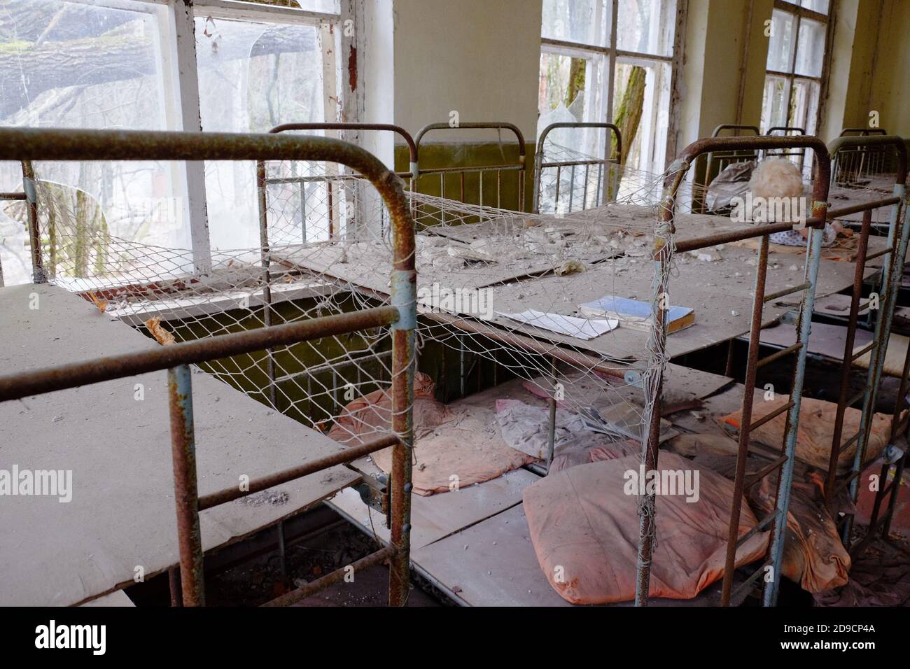 Old children's beds in an abandoned kindergarten. The interior of a ...