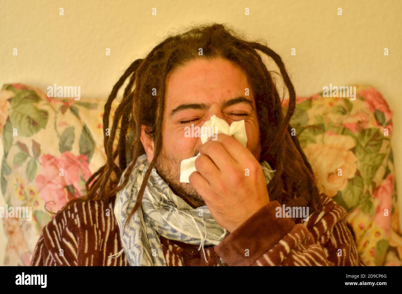 Spanish man cleaning his nose while in self-isolation at his home on a ...