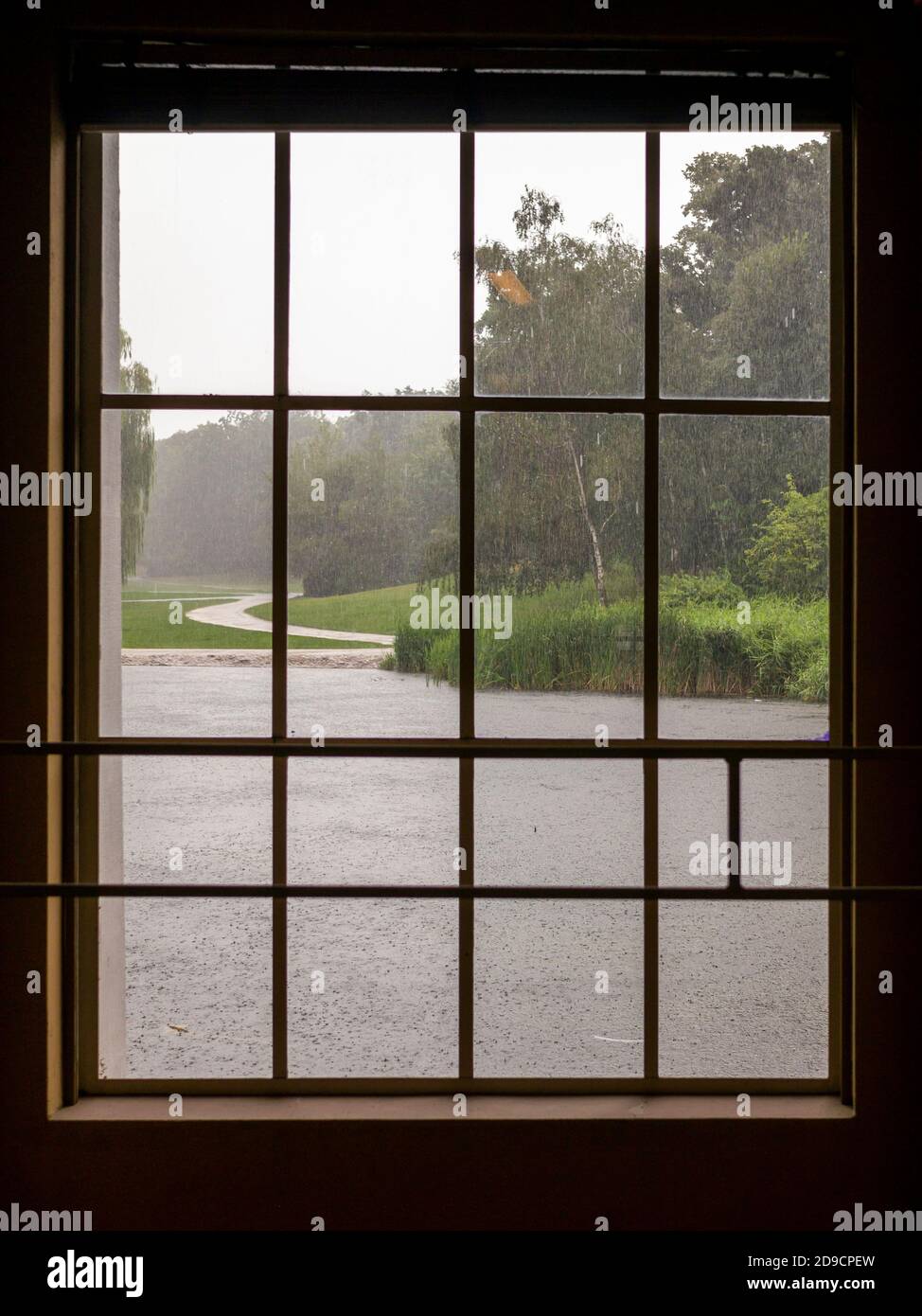 a rainy park and lake viewed through a window Stock Photo - Alamy