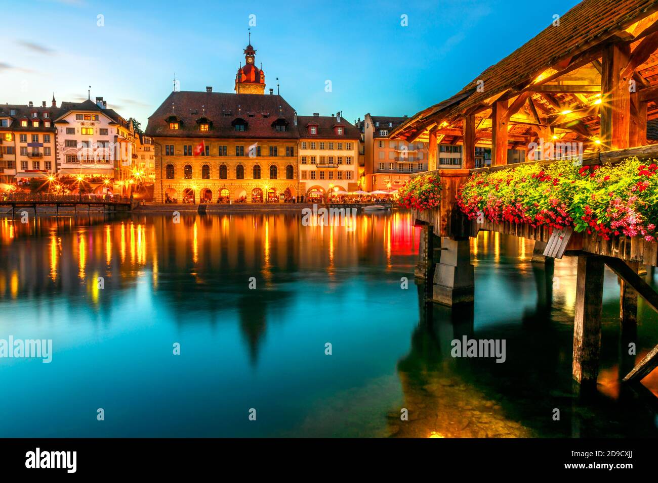 Lucerne flowery Chapel Bridge at night reflected on river. Amazing ...
