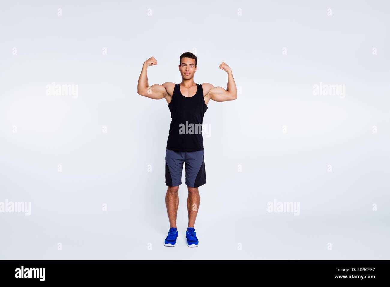 Strong bodybuilder demonstrating muscular body hi-res stock photography ...