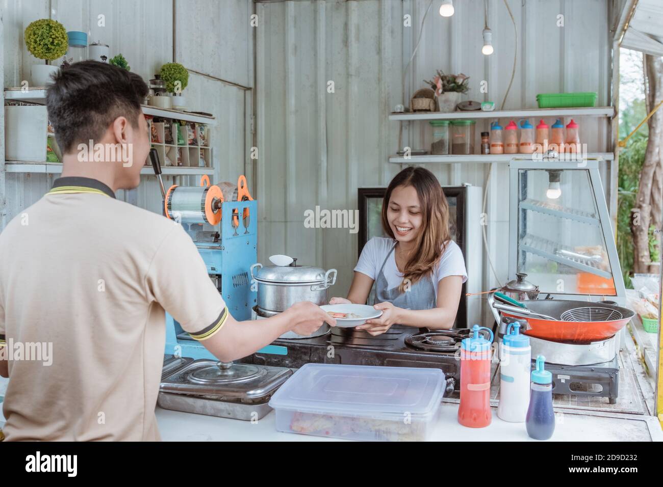 The man took his own food to be cooked by waiters Stock Photo - Alamy