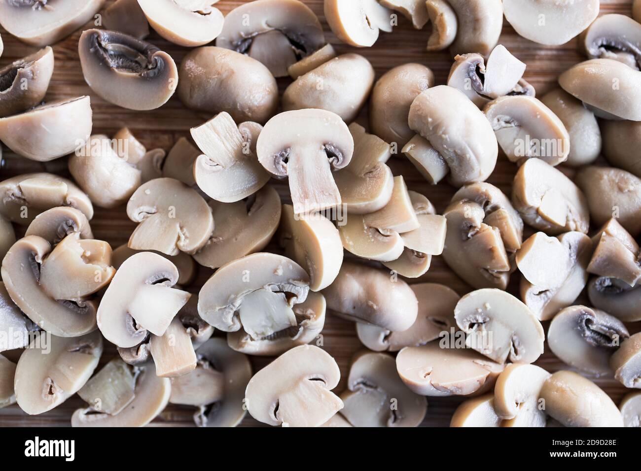simple food ingredients concept, champignon mushrooms cut in halves on ...