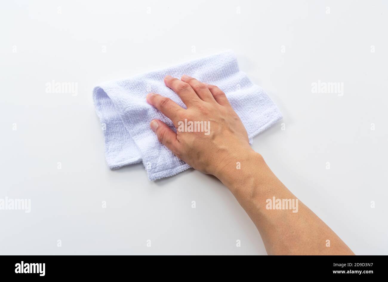 A man's hand on a white background with a rag. A view from above Stock ...