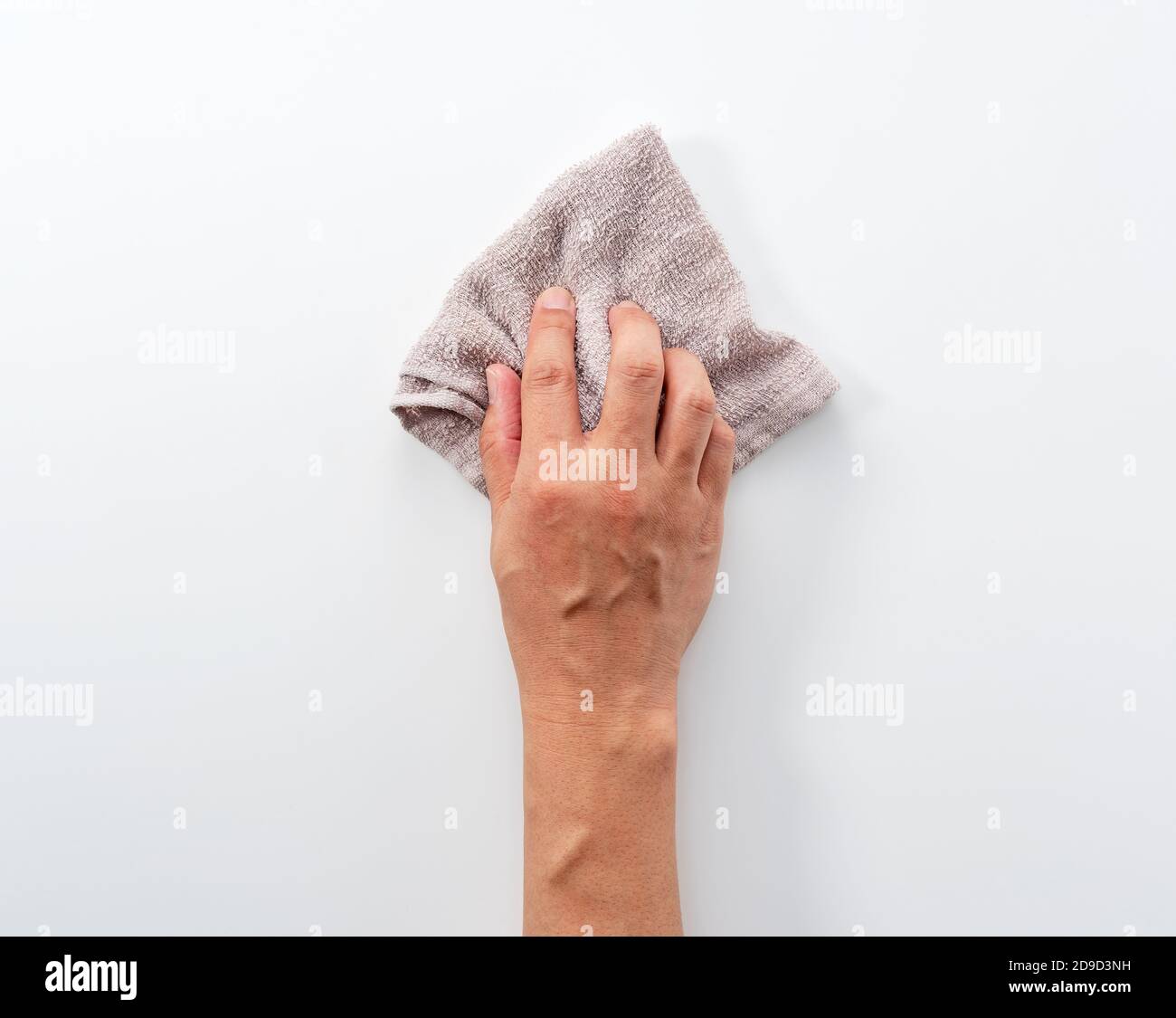 A man's hand on a white background with a rag. A view from above Stock ...