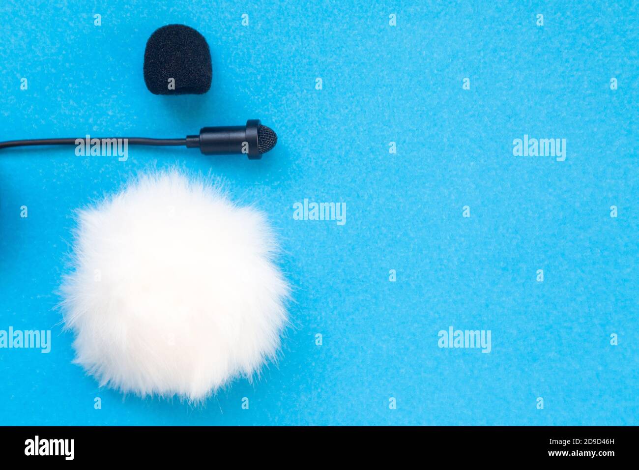 Lavalier small microphone and wind protection on blue background Stock ...