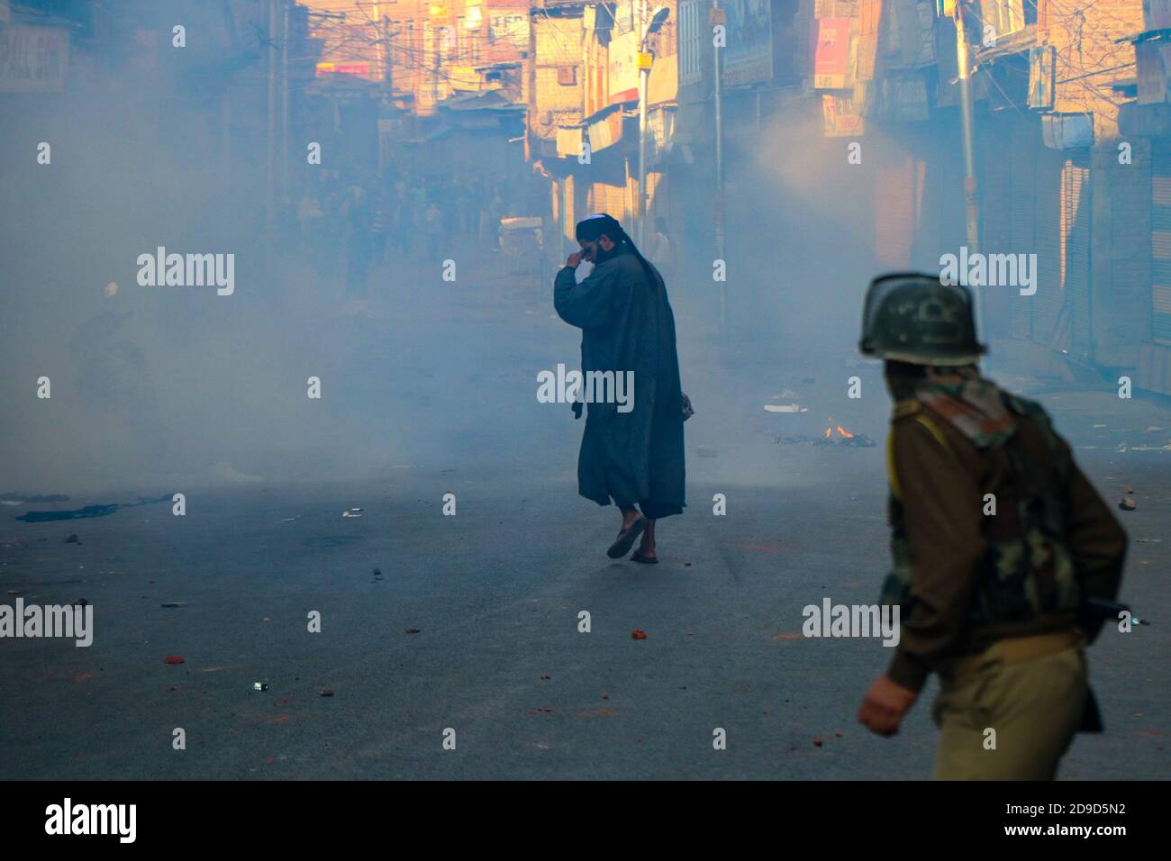 A soldier watching a man walking by in kashmir, India Stock Photo - Alamy