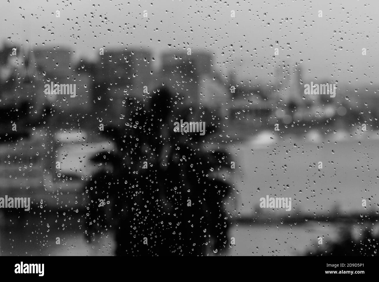 Grayscale shot of a glass window with rain drops Stock Photo - Alamy