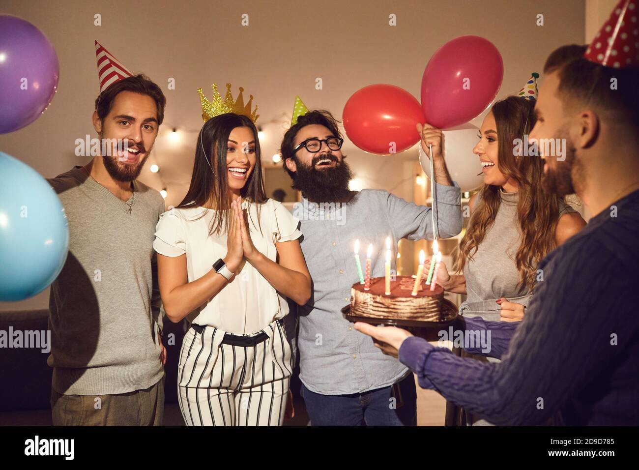 Group of students giving a cake to their groupmate and wishing her a ...