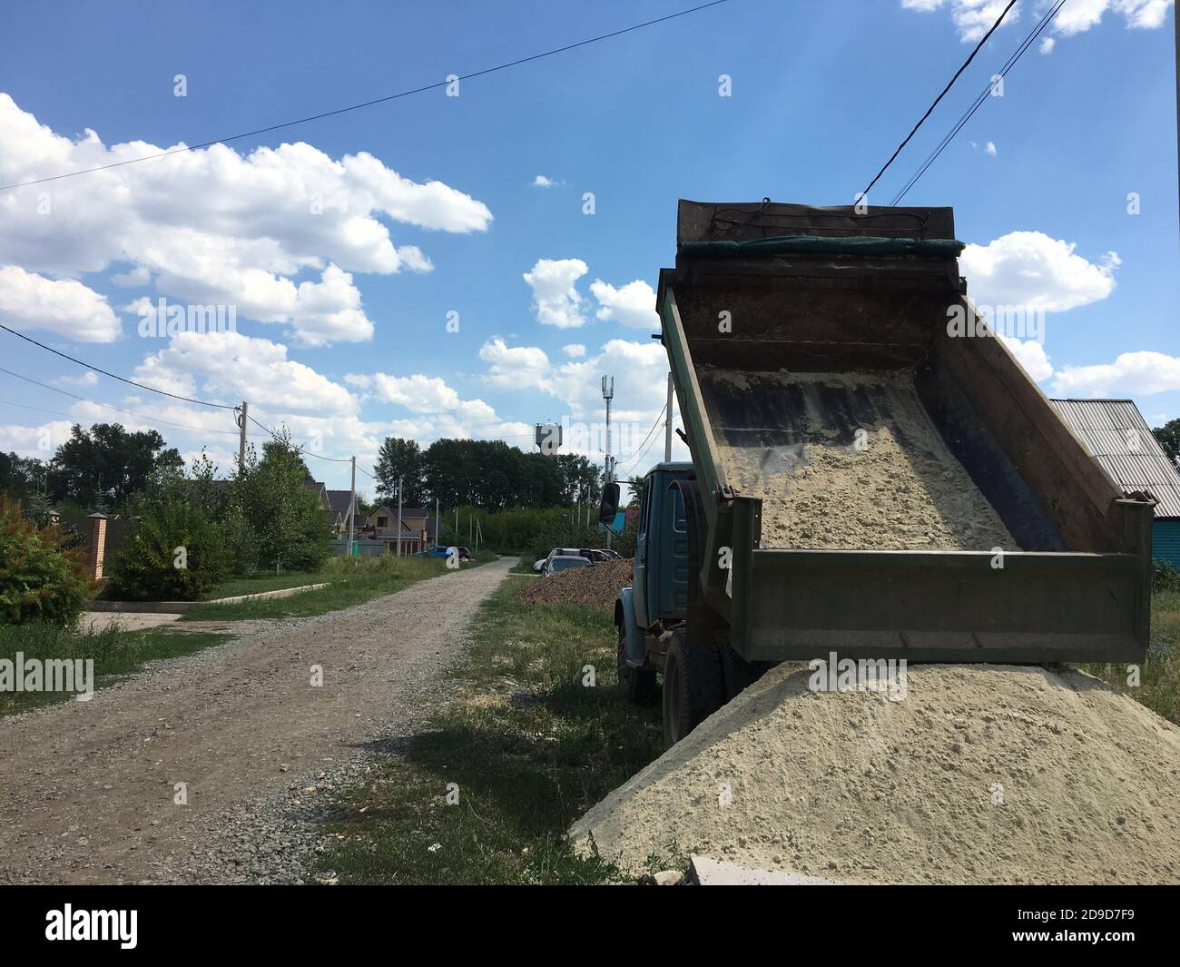 A truck brought sand for the construction site. Bulk cargo delivery ...