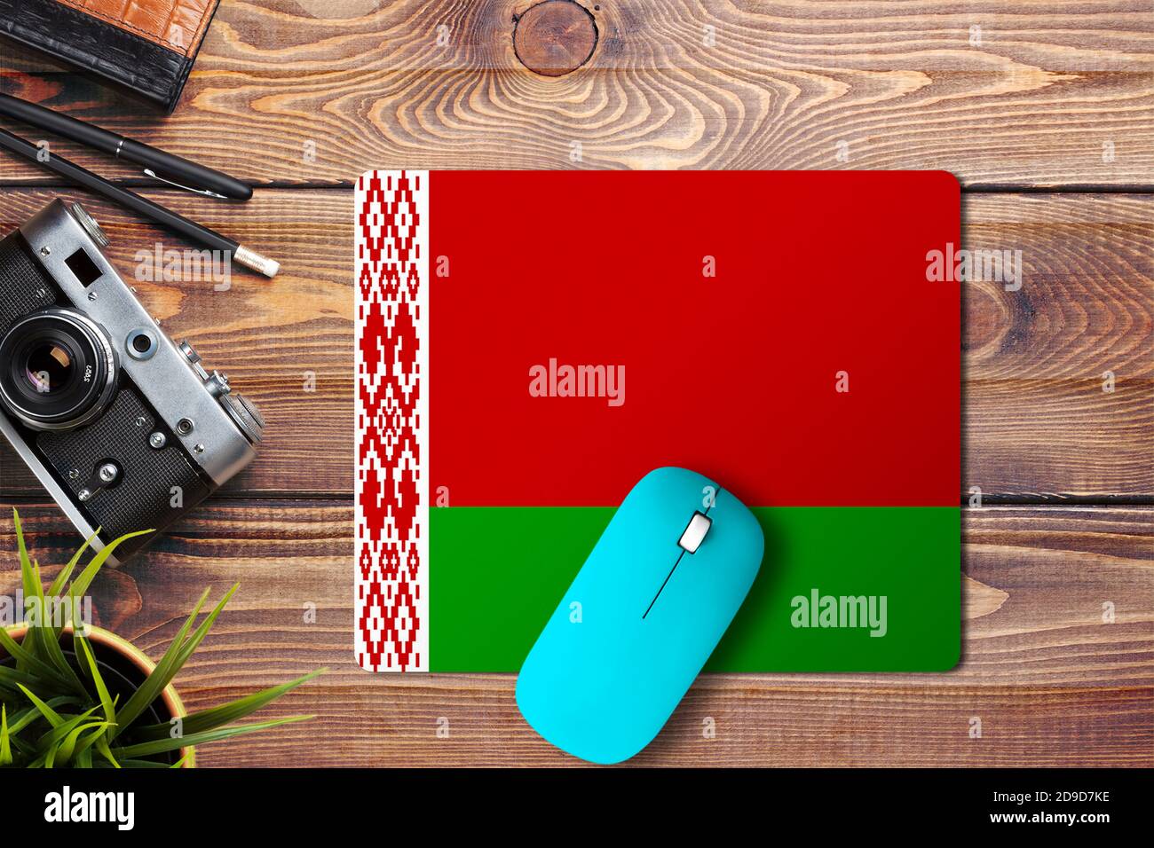 Belarus flag on wooden background with blue wireless mouse on a mouse ...
