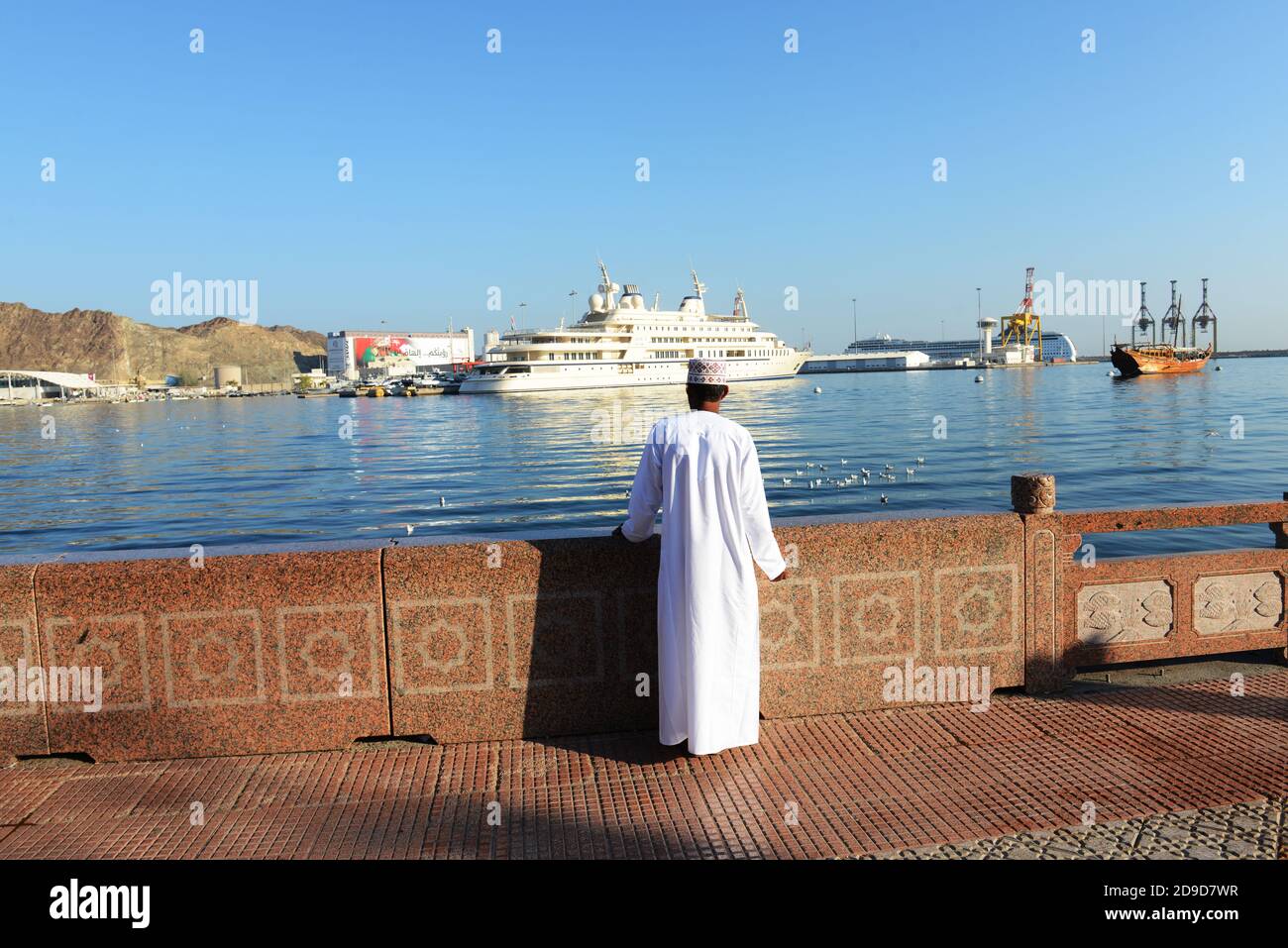 An Omani man walking on the Mutrah corniche in Oman Stock Photo - Alamy