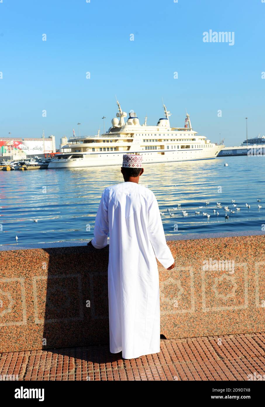 An Omani man walking on the Mutrah corniche in Oman Stock Photo - Alamy