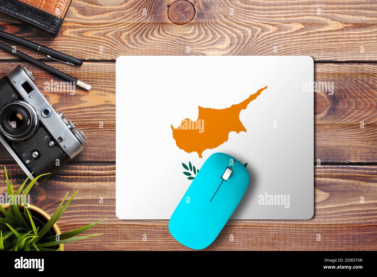 Cyprus flag on wooden background with blue wireless mouse on a mouse ...