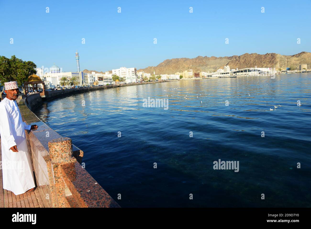 An Omani man walking on the Mutrah corniche in Oman Stock Photo - Alamy