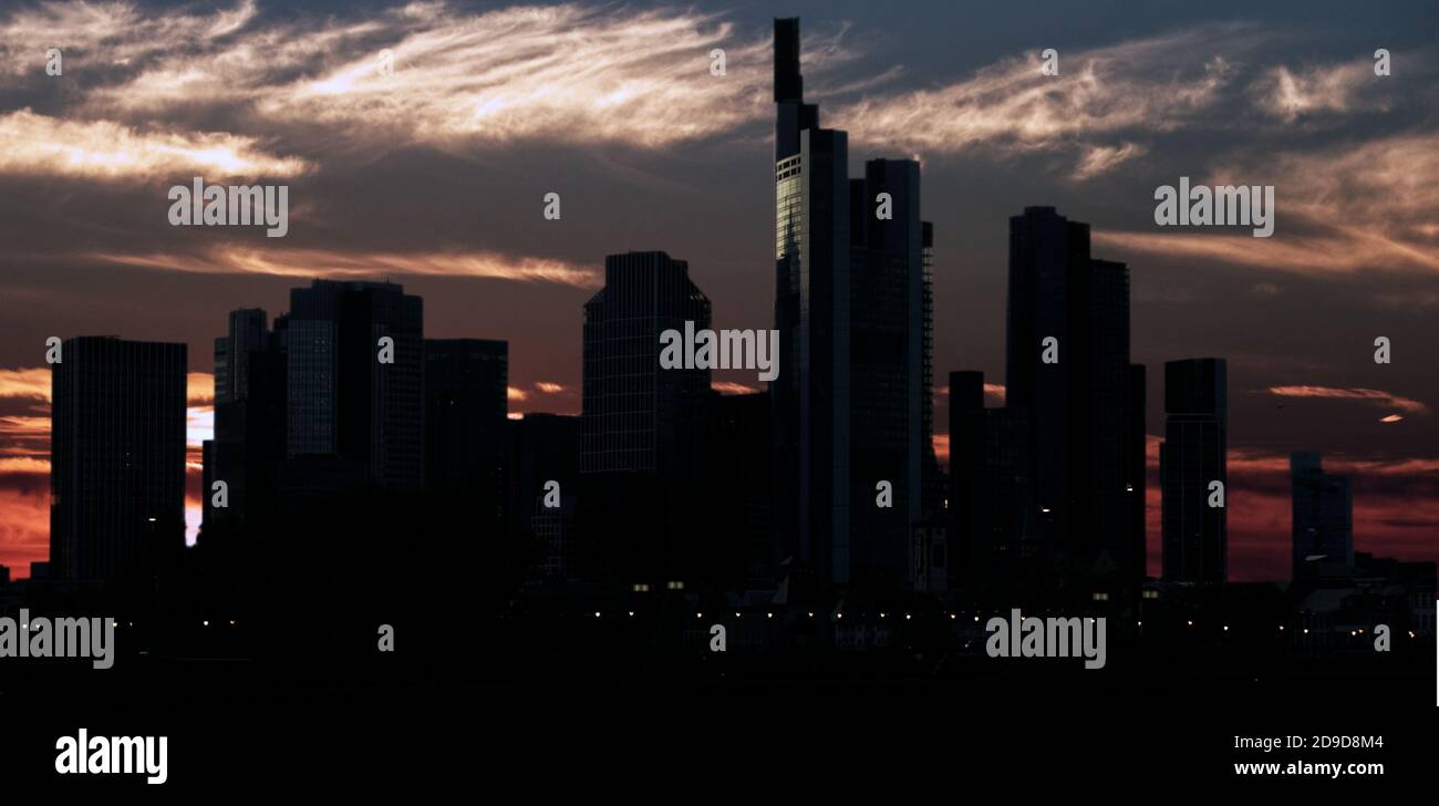 Dark skyline of a big city with skyscrapers in front of a dramatic sky ...