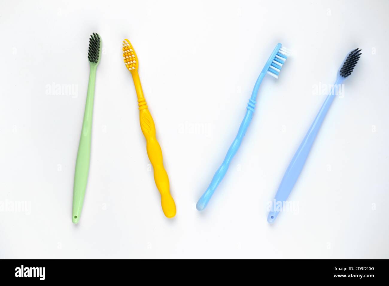 Photo of four colorful toothbrushes on isolated white background Stock ...