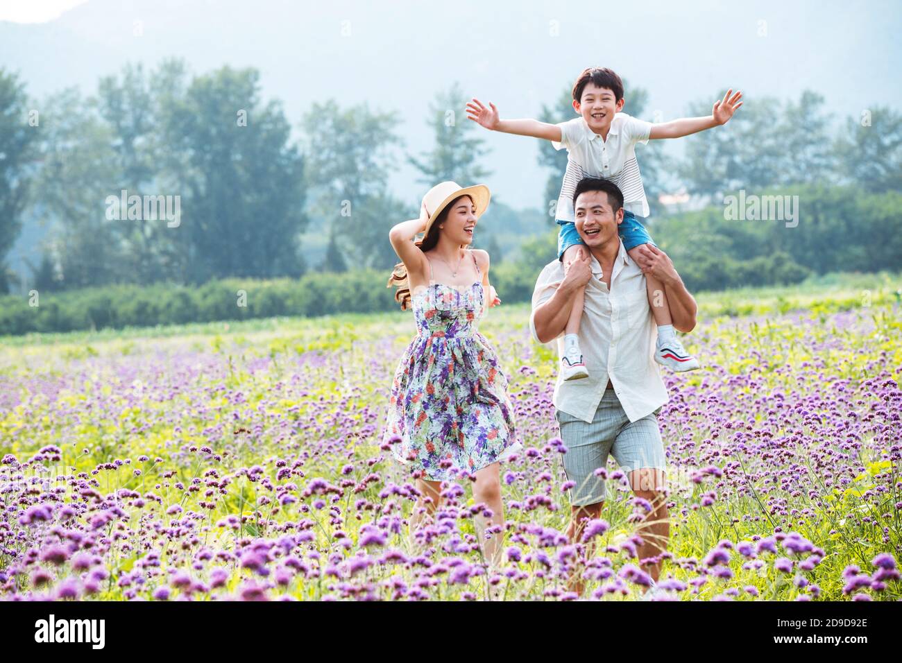 Happy three play outdoors Stock Photo - Alamy