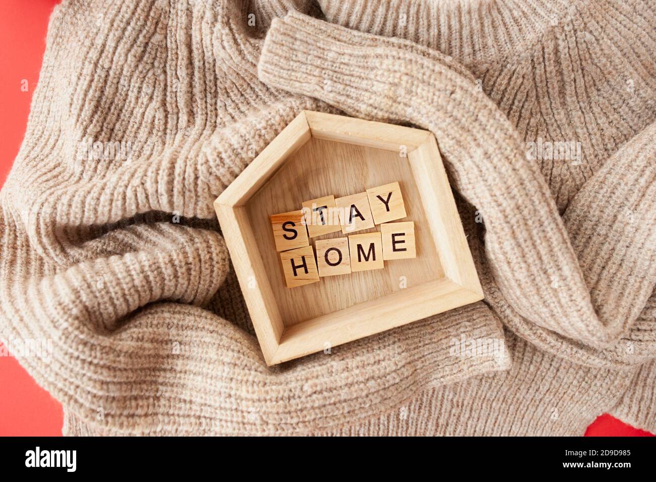 stay at home, lettering in wooden square letters in small wooden house ...