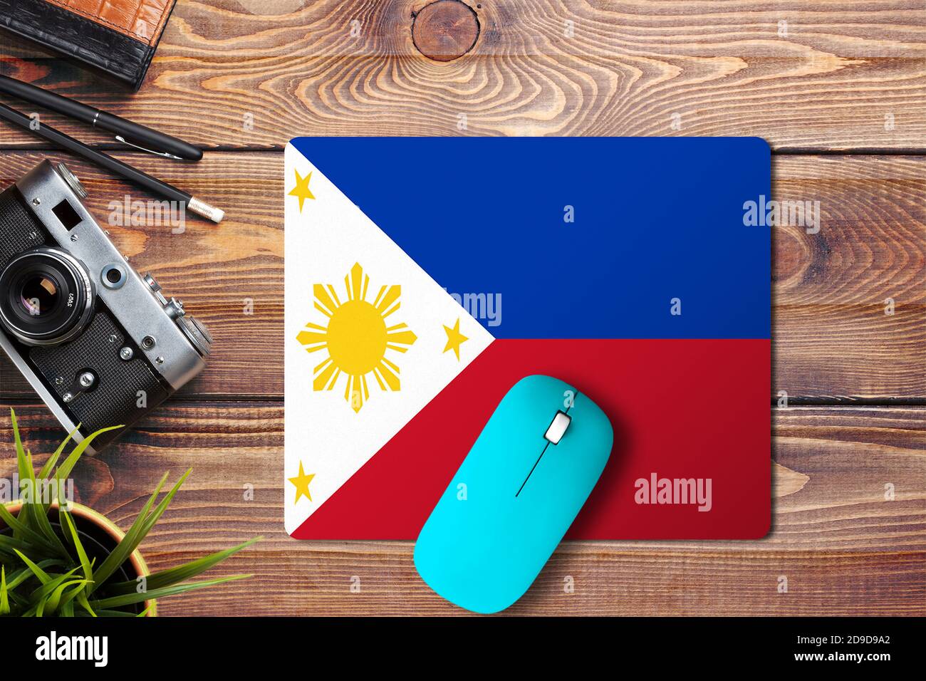 Philippines flag on wooden background with blue wireless mouse on a ...