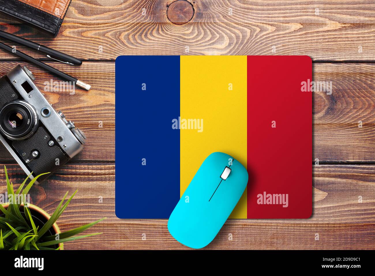 Romania flag on wooden background with blue wireless mouse on a mouse ...