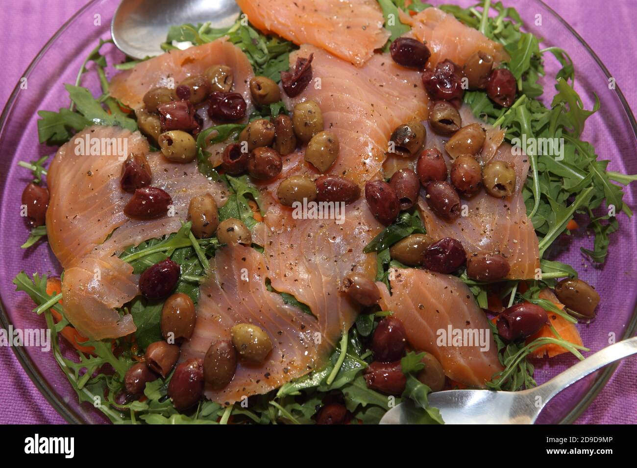 fish dishes: smoked salmon with olives Stock Photo - Alamy