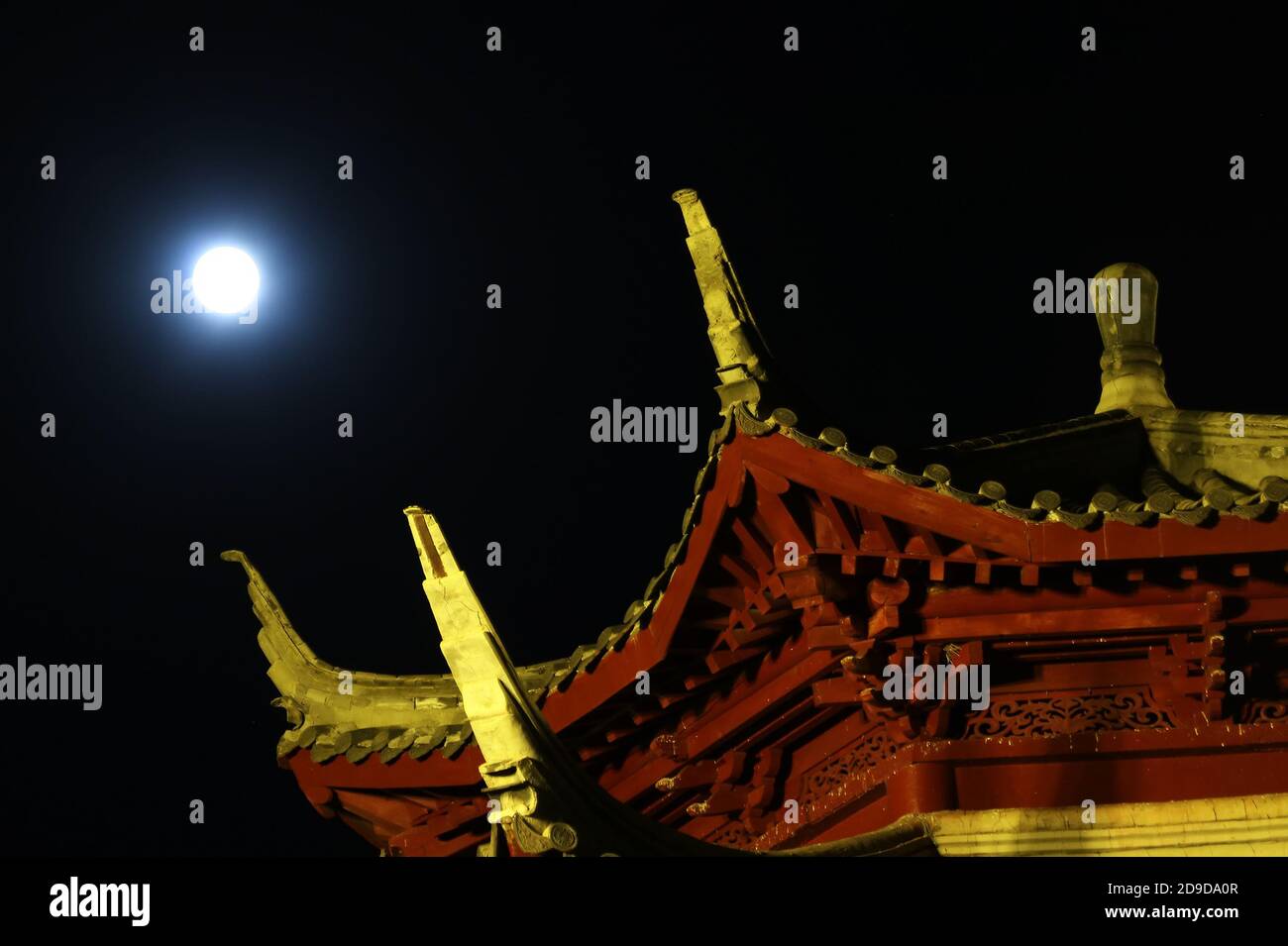A full moon is seen above traditional Chinese-style building at Mid ...