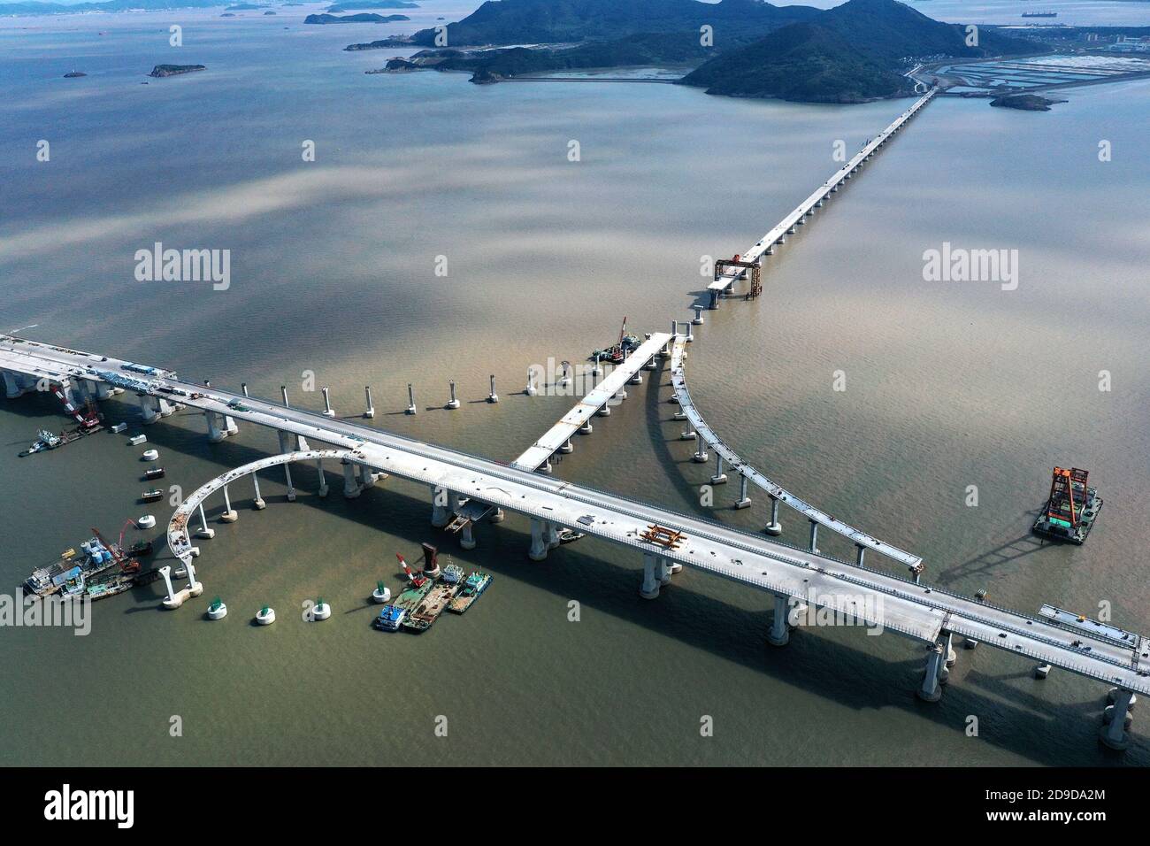 An aerial view of workers building the Zhoudai Bridge, which connect ...