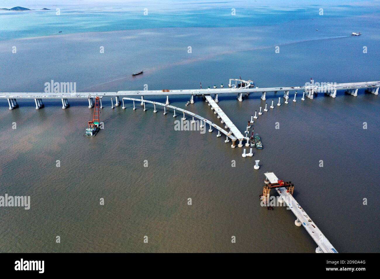 An aerial view of workers building the Zhoudai Bridge, which connect ...