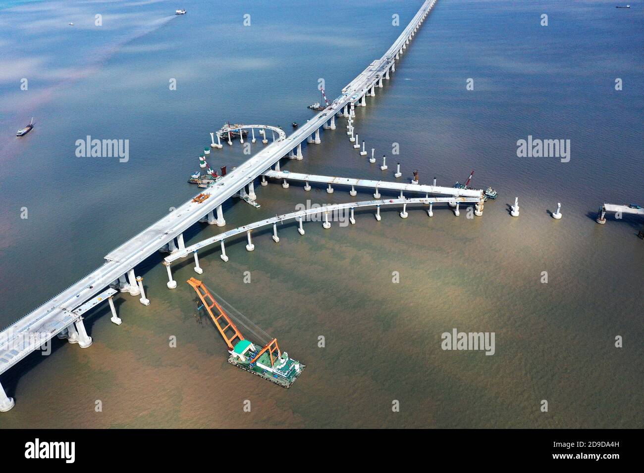 An aerial view of workers building the Zhoudai Bridge, which connect ...