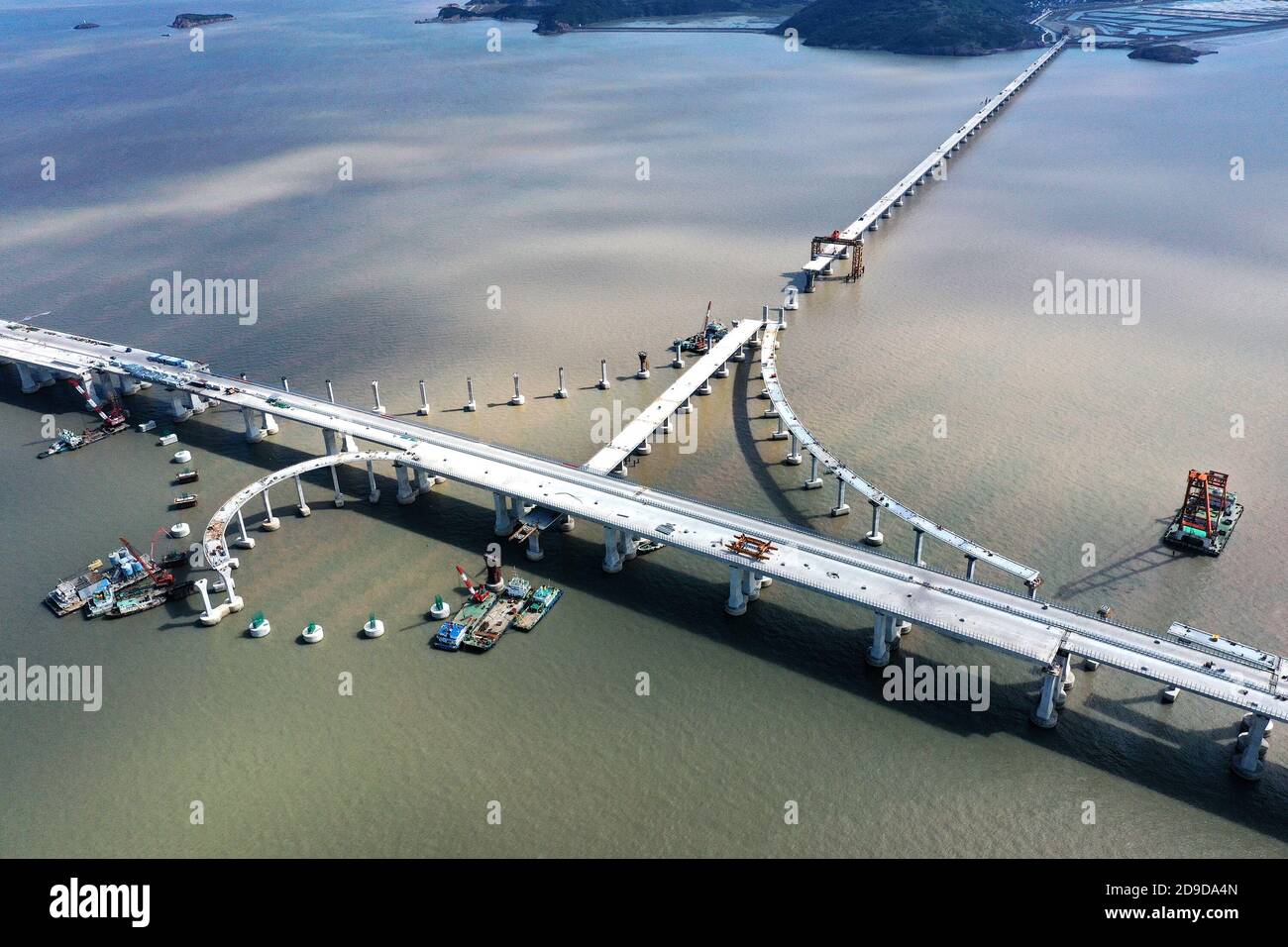 An aerial view of workers building the Zhoudai Bridge, which connect ...