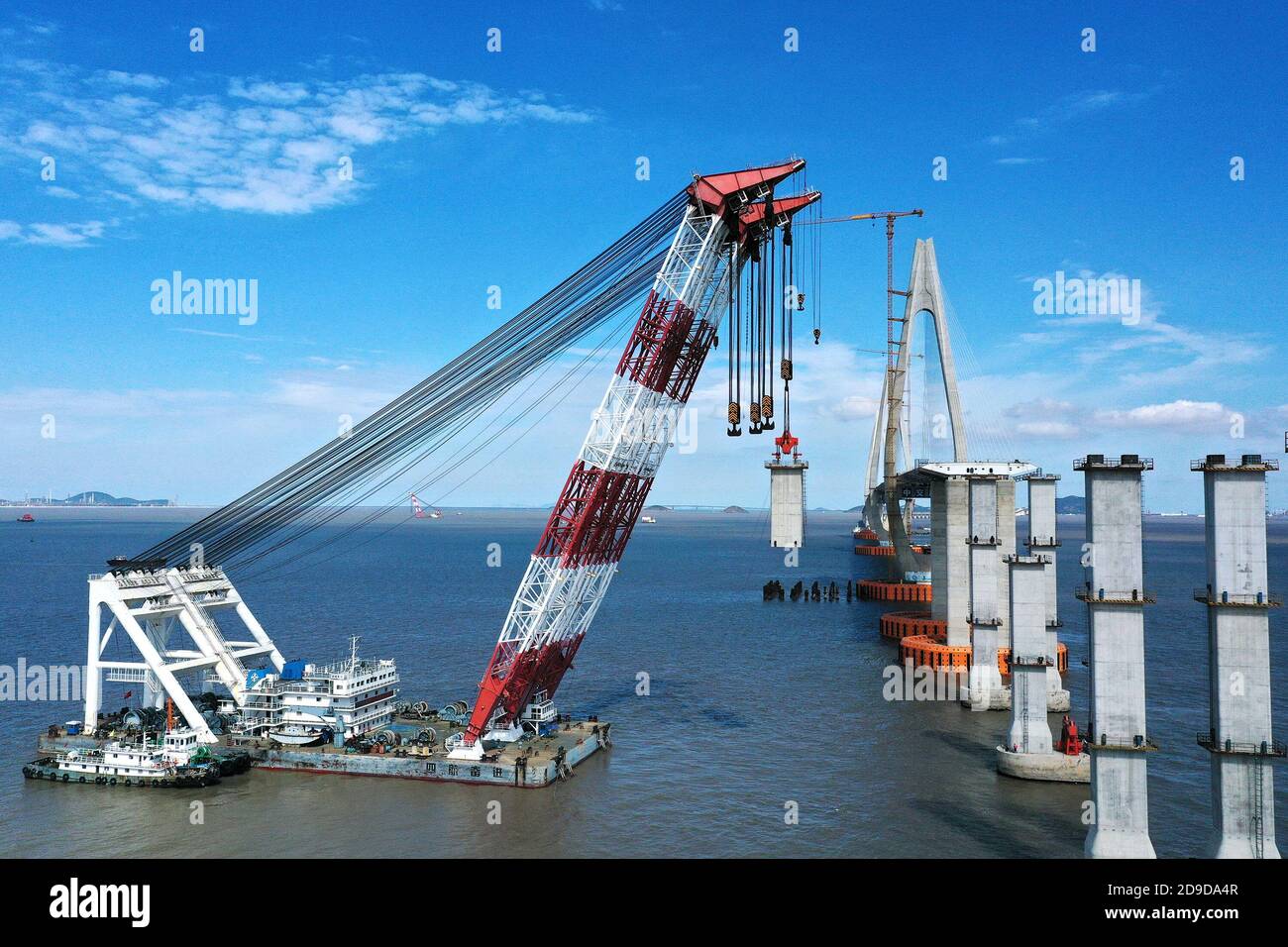 An aerial view of a crane working to build the Zhoudai Bridge, which ...