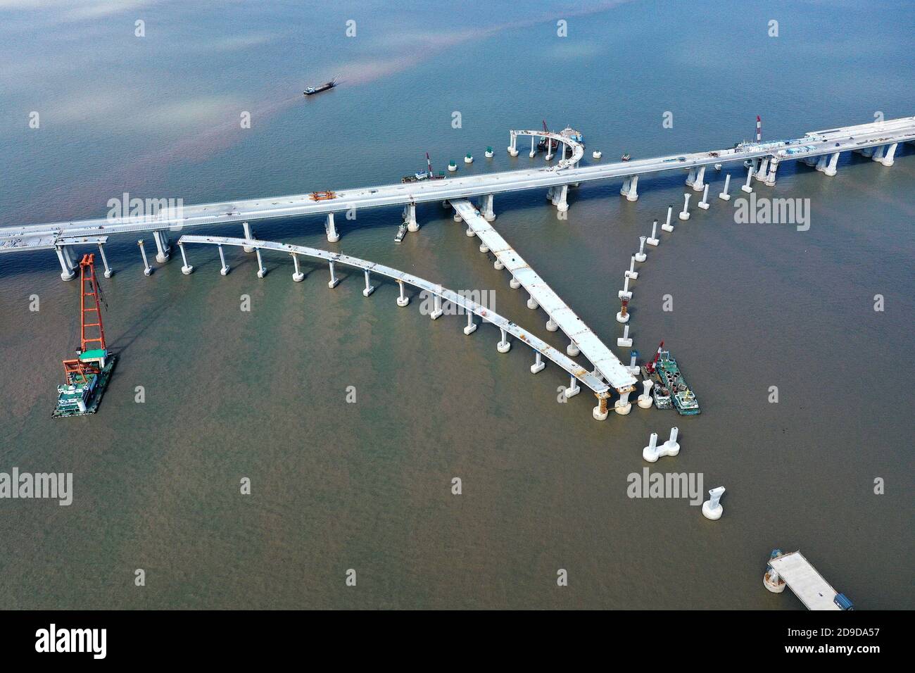 An aerial view of workers building the Zhoudai Bridge, which connect ...