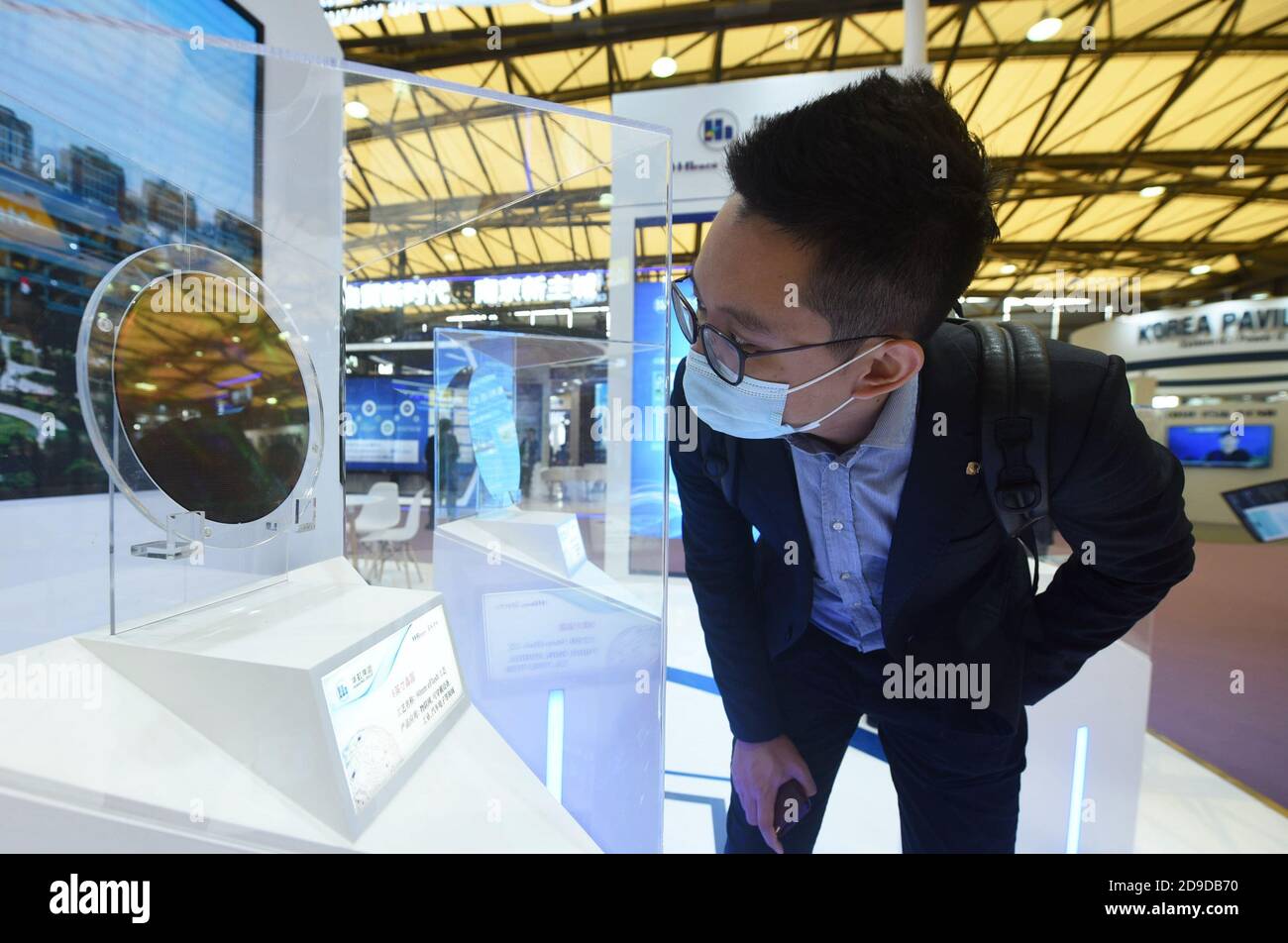 Visitors carefully observe various kinds of chips are exhibited at ...