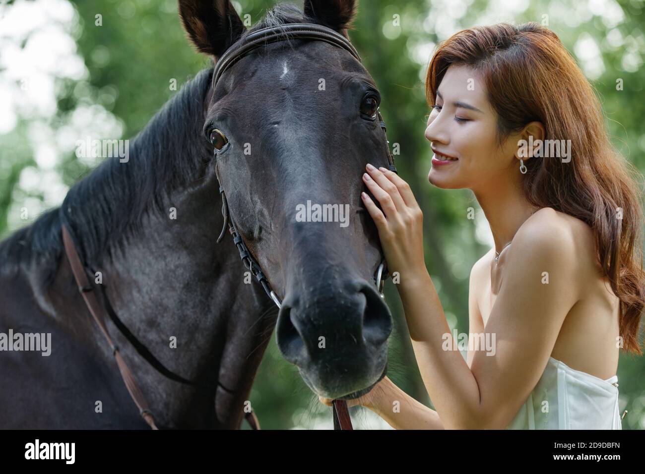 Outdoor beautiful youth woman caress matt wrote Stock Photo - Alamy