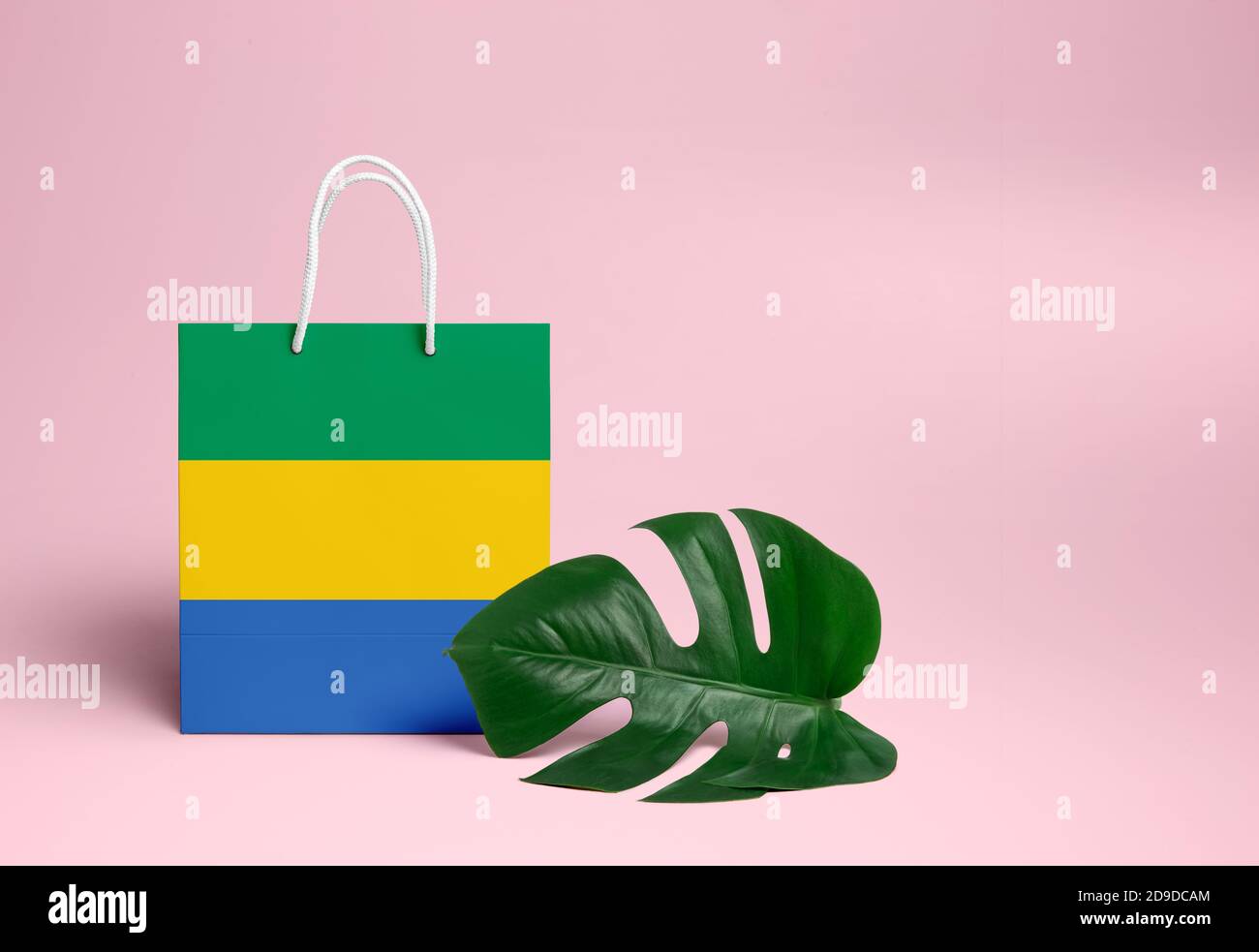 Gabon shopping concept. National cardboard shopping bag with monstera ...
