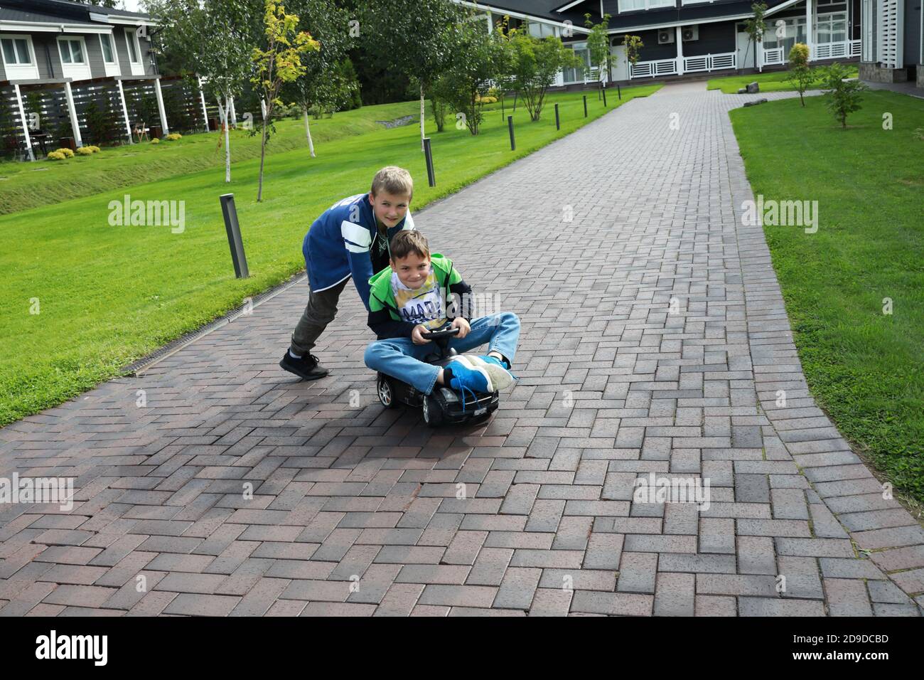 Children pushing toy car hi-res stock photography and images - Alamy