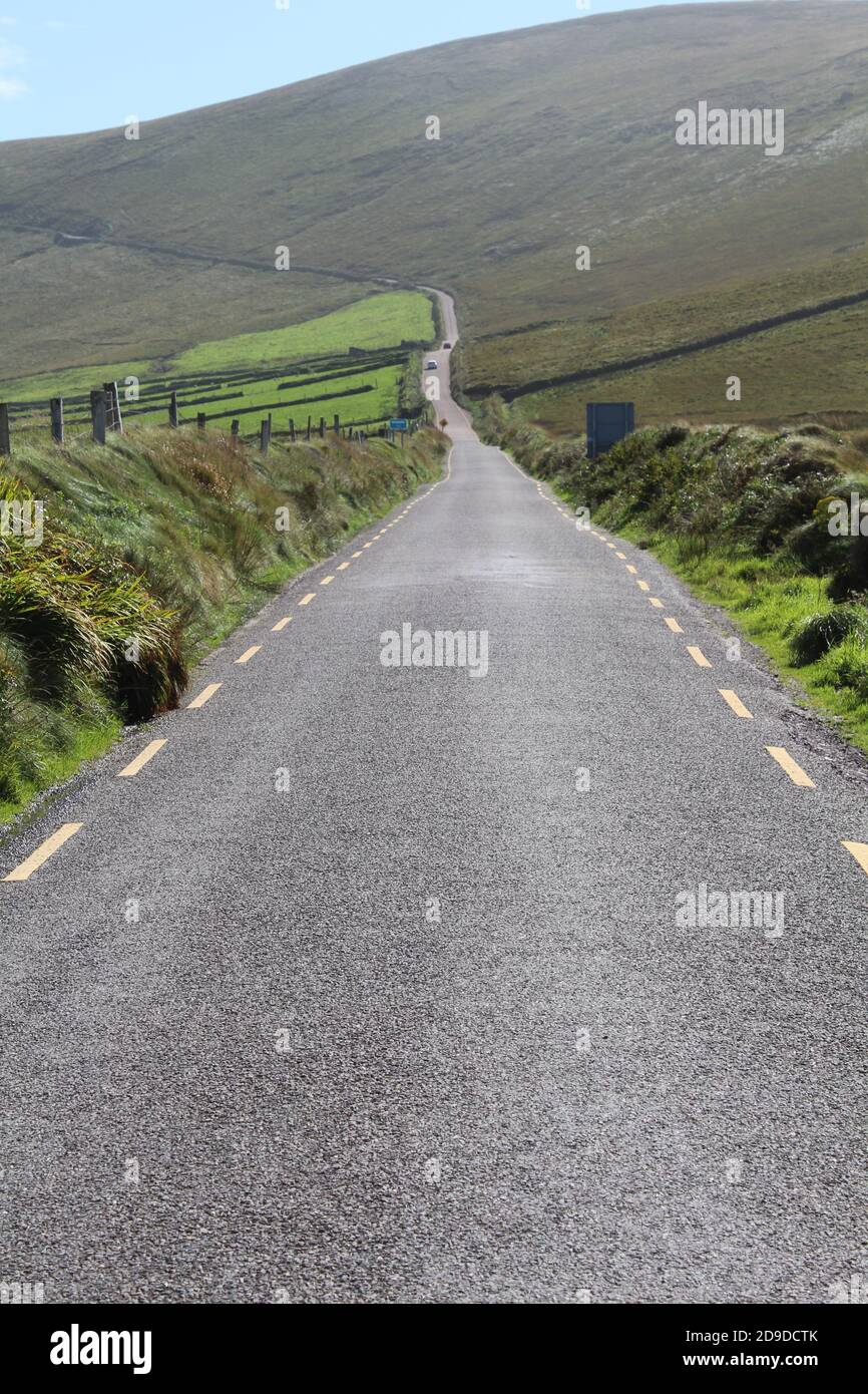 Vertical shot of a road with greenery in the countryside Stock Photo ...