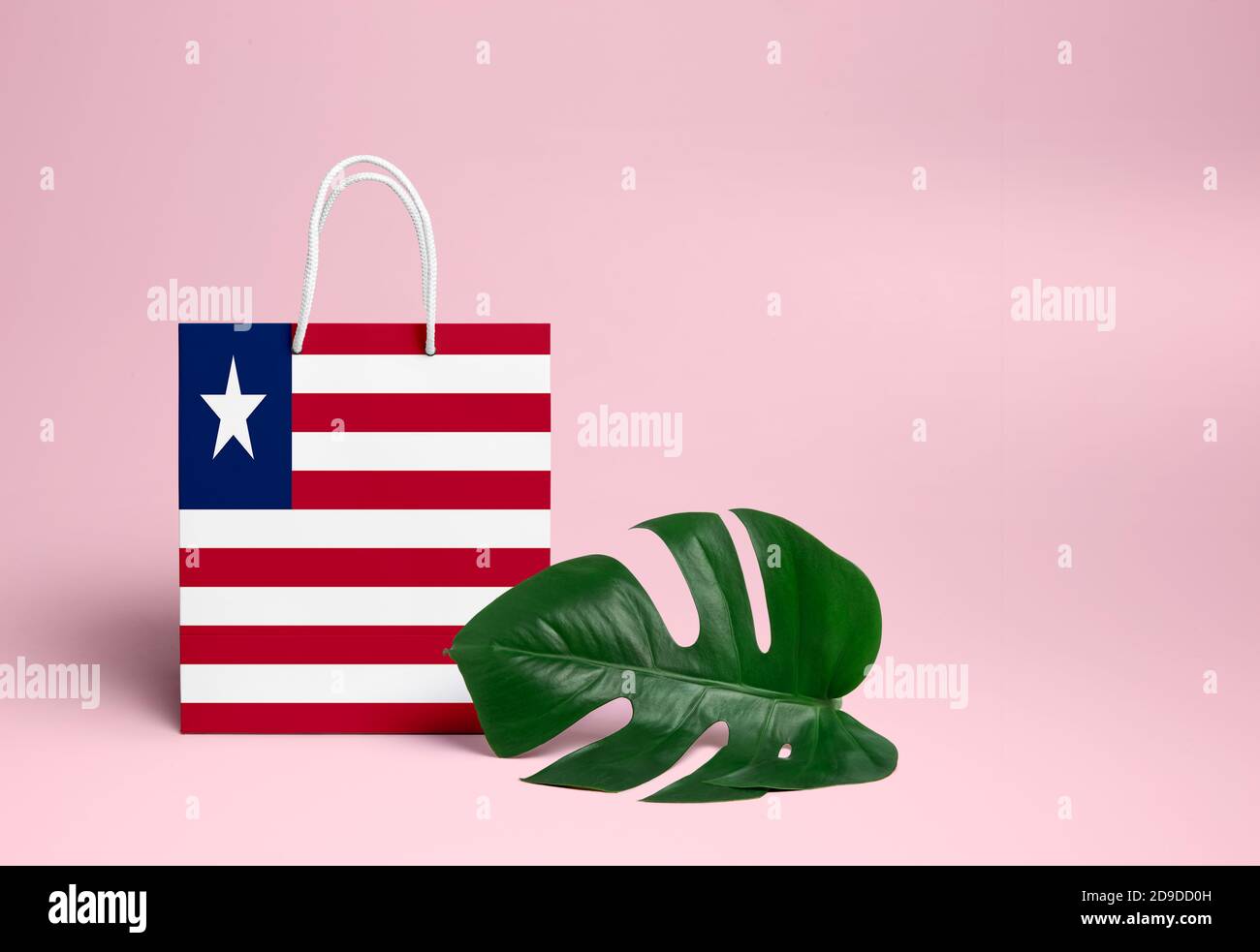 Liberia shopping concept. National cardboard shopping bag with monstera ...