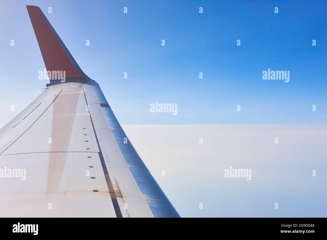 Aeroplane wing over a blue sky background. Fly transport Stock Photo ...
