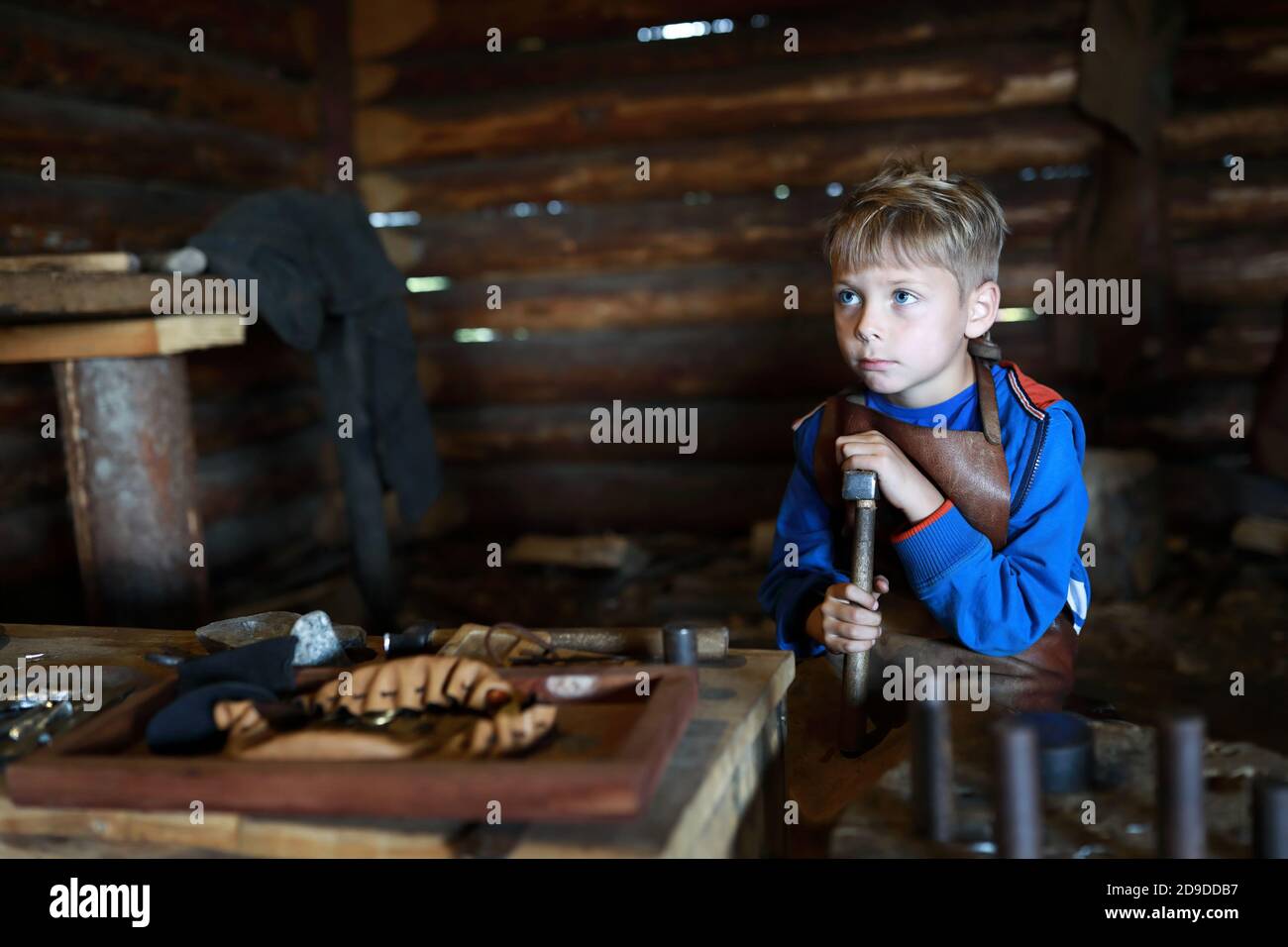 Portrait of child with hammer in forge Stock Photo - Alamy