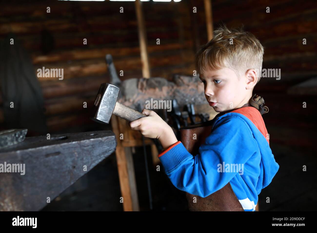 Boy forging with blacksmith hi-res stock photography and images - Alamy