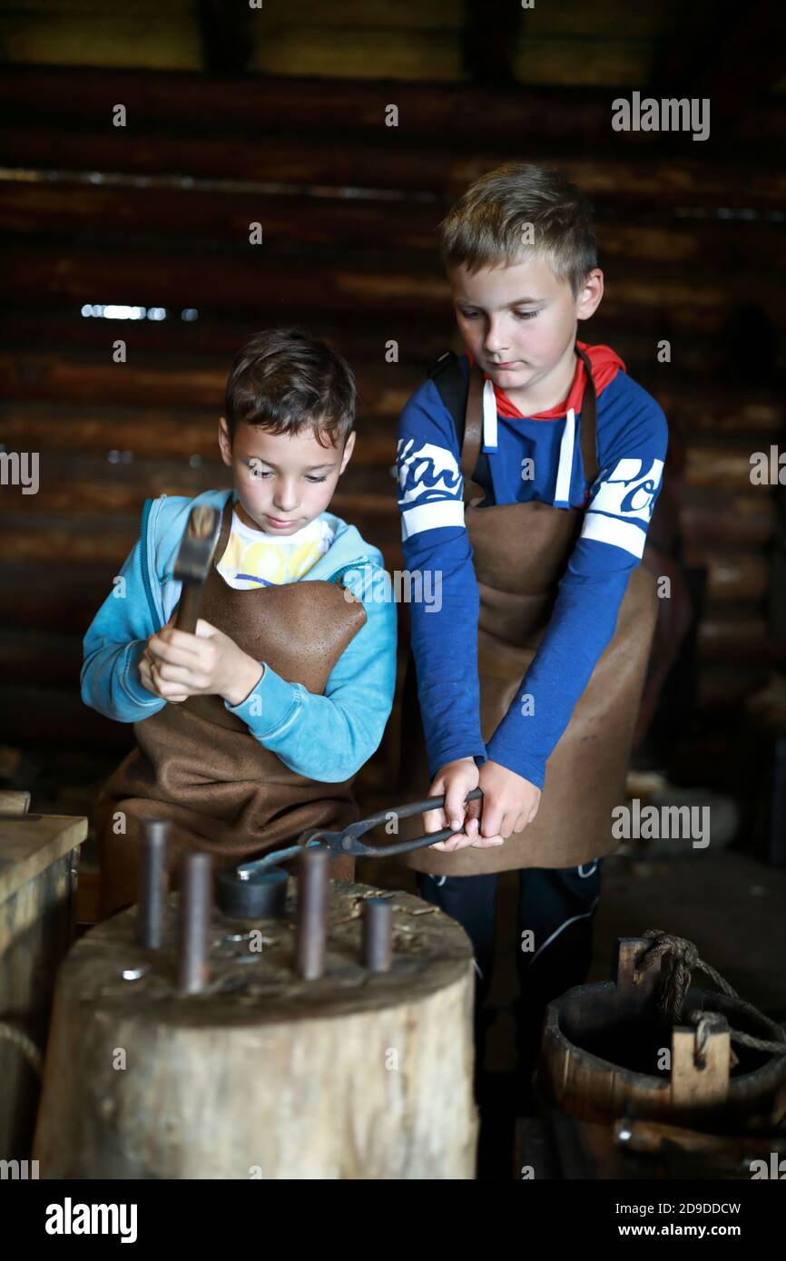 Boy forging with blacksmith hi-res stock photography and images - Alamy