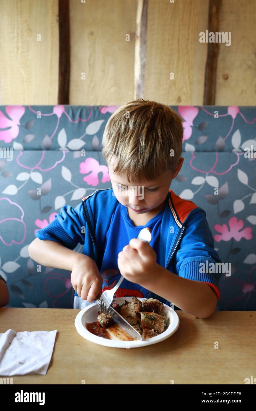 Child has pork kebab in a restaurant Stock Photo - Alamy